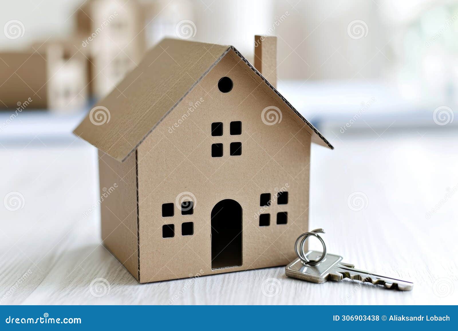 A Model of a Cardboard House on a Table with a Key Stock Photo - Image ...