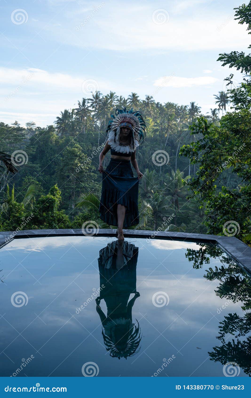 Model Dressed in American Indian Posing on an Edge of Infinity Pool in ...