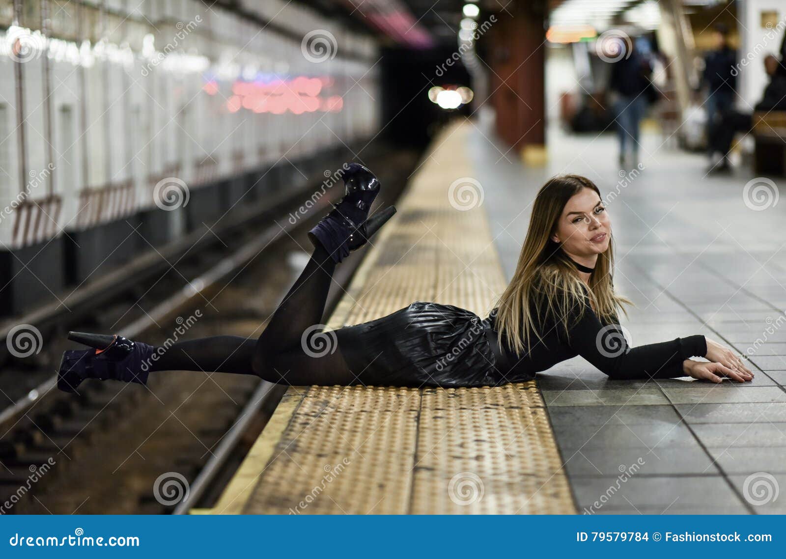 Model Lying at the Edge of Subway Platform. Stock Photo - Image of ...