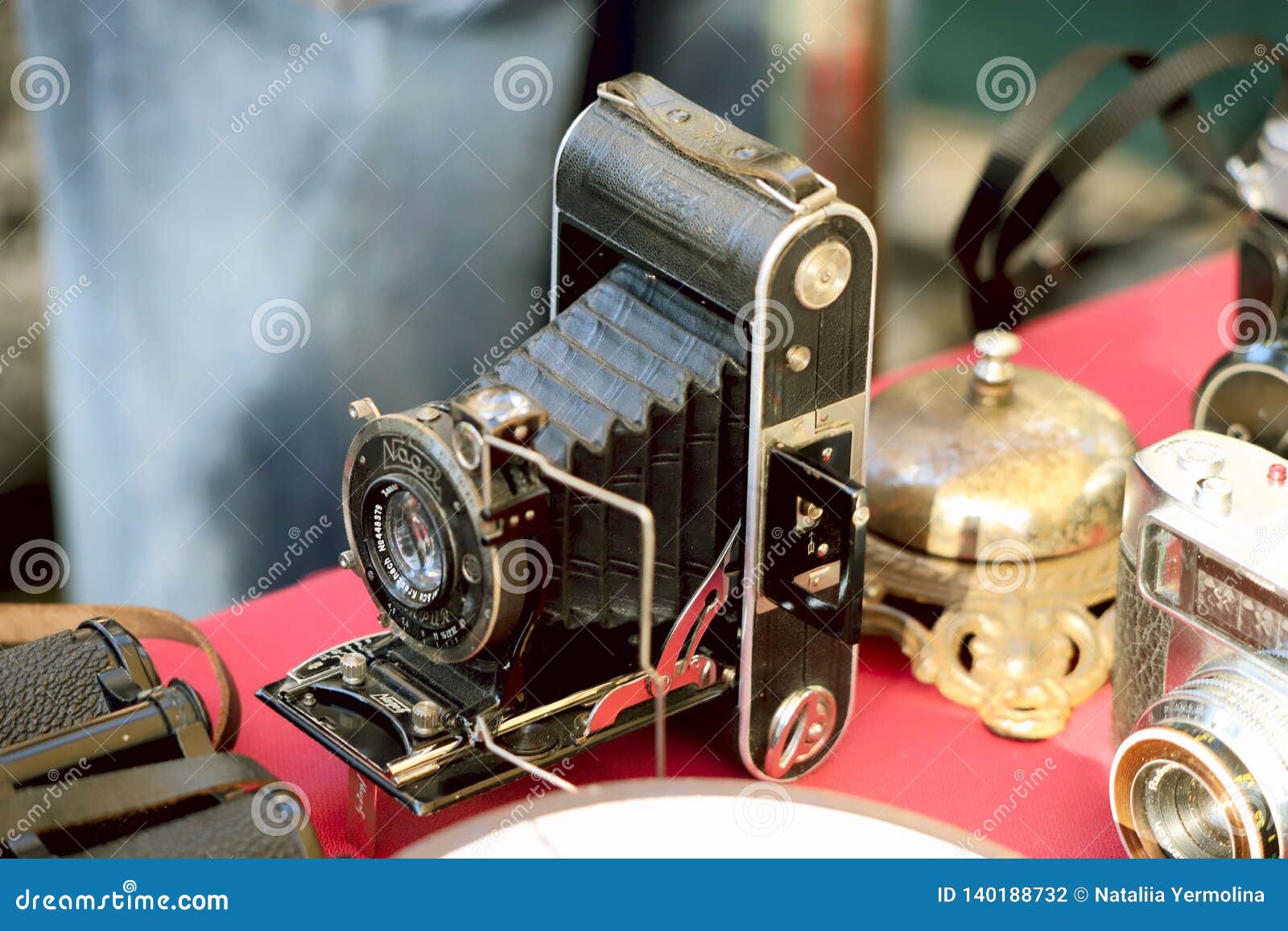 Model of an Old Camera on a Table at a Flea Market. Old-time Items on ...
