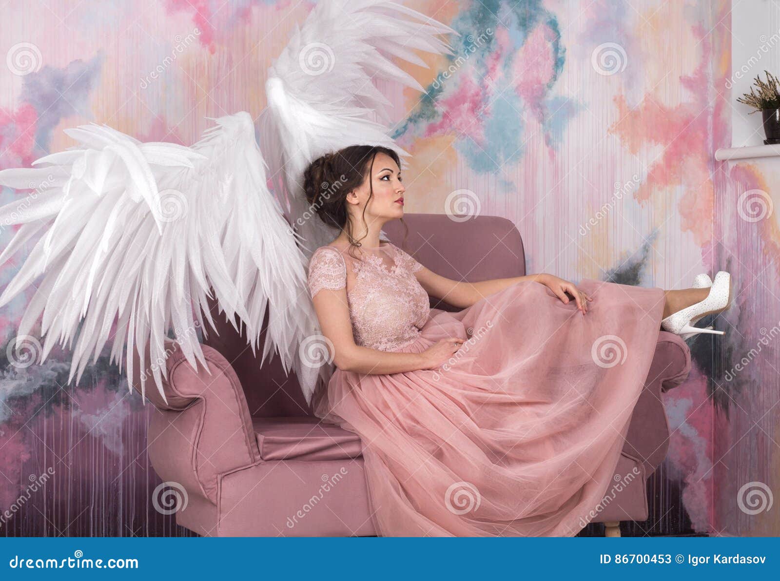 Model with Open Angel Wings Sitting on Sofa Stock Image - Image of good ...