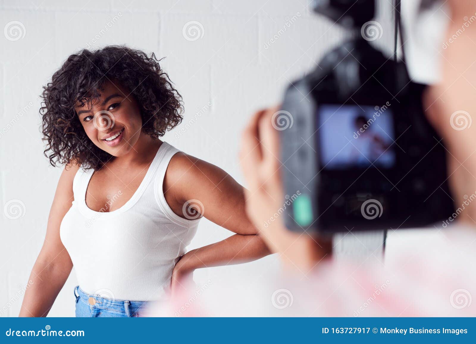 Model Posing for Female Photographer in Studio Portrait Session Stock ...