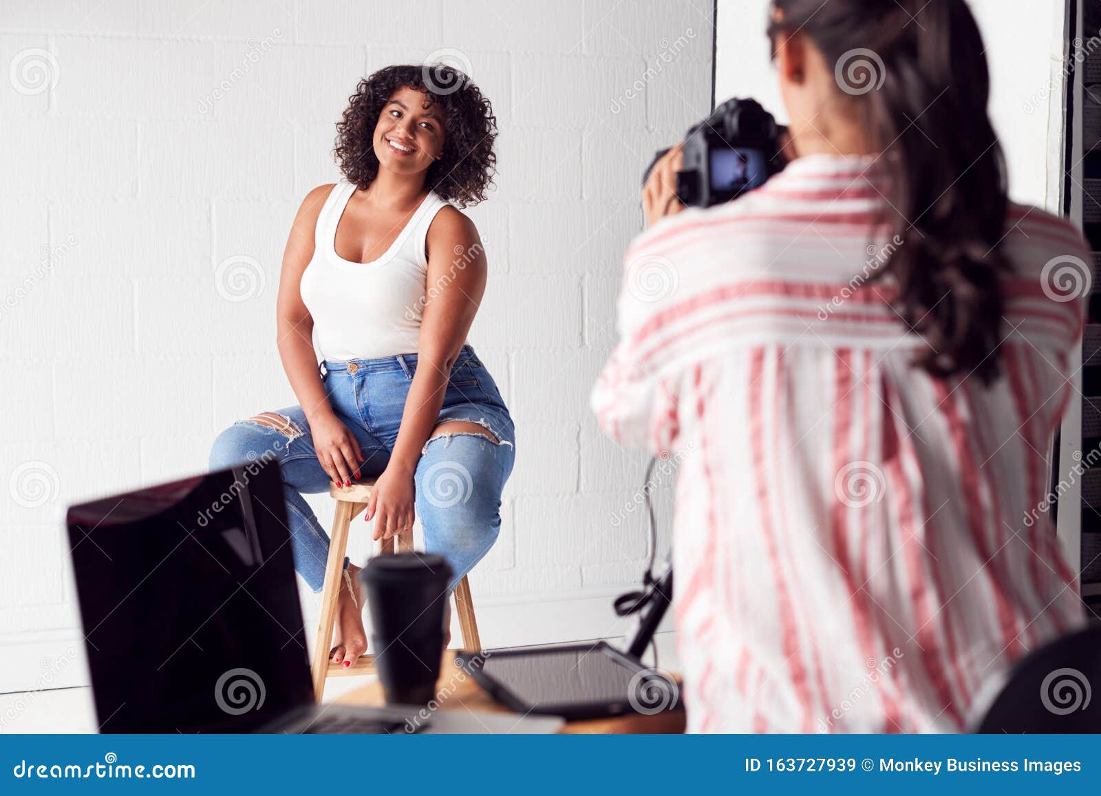 Model Posing for Female Photographer in Studio Portrait Session Stock ...