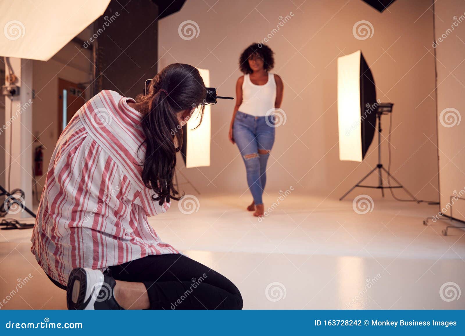 Model Posing for Female Photographer in Studio Portrait Session Stock ...