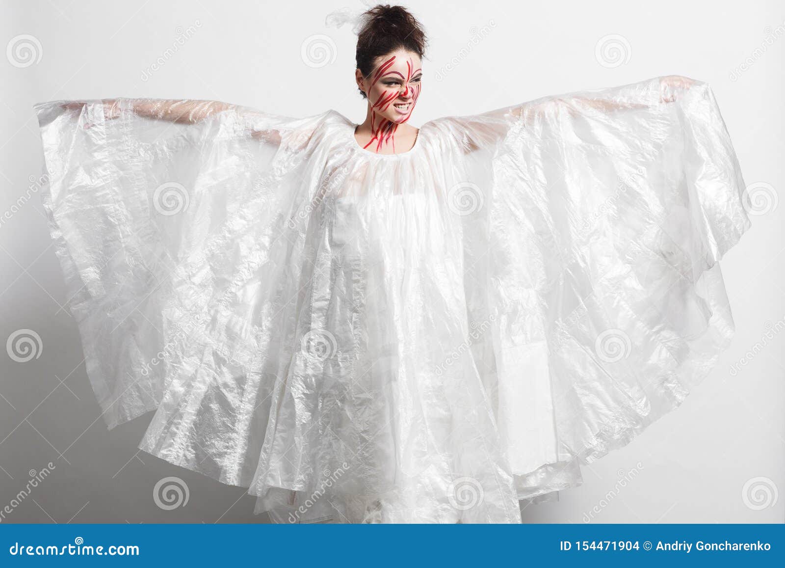 Model in a Raincoat Made of Cellophane and in Creative Make-up Stock ...