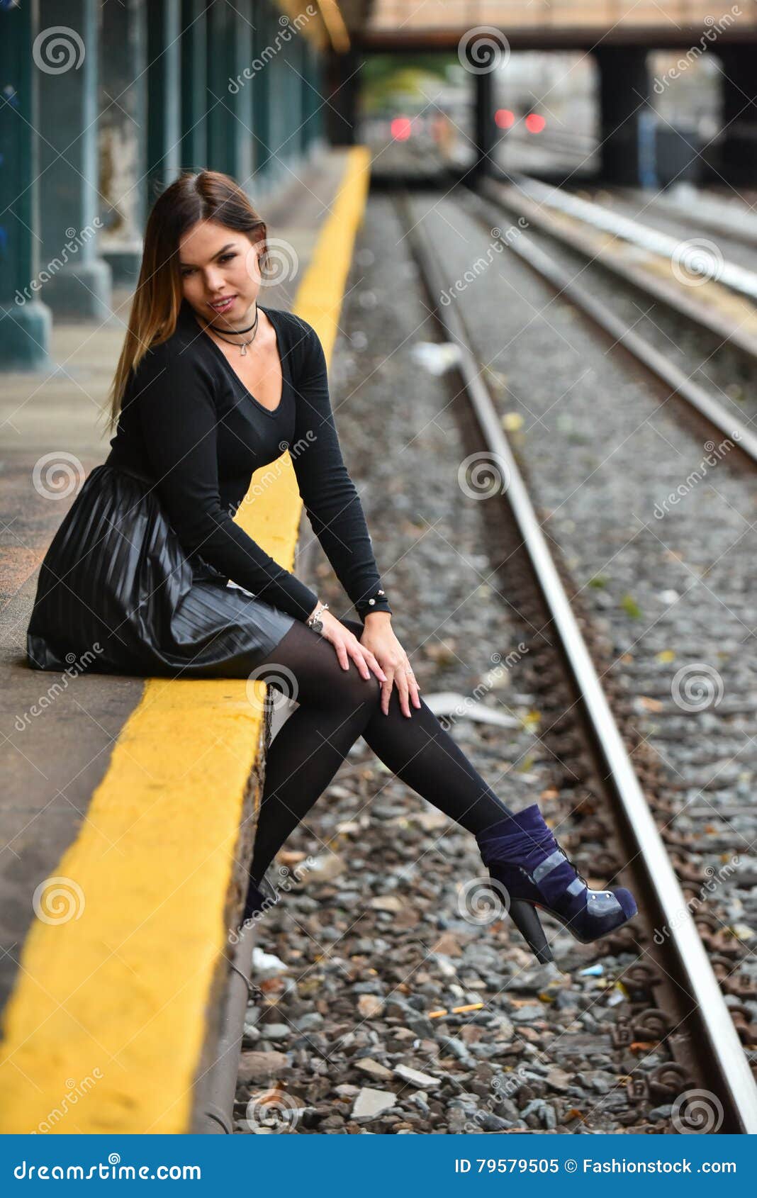 Model Sitting at the Edge of Subway Platform. Stock Image - Image of ...
