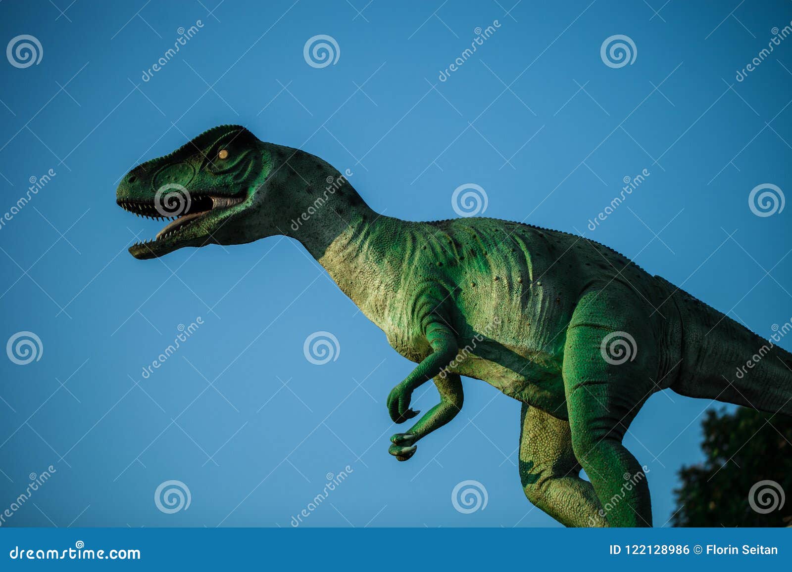 Model of Velociraptor Roaring Against Blue Sky Stock Photo - Image of ...