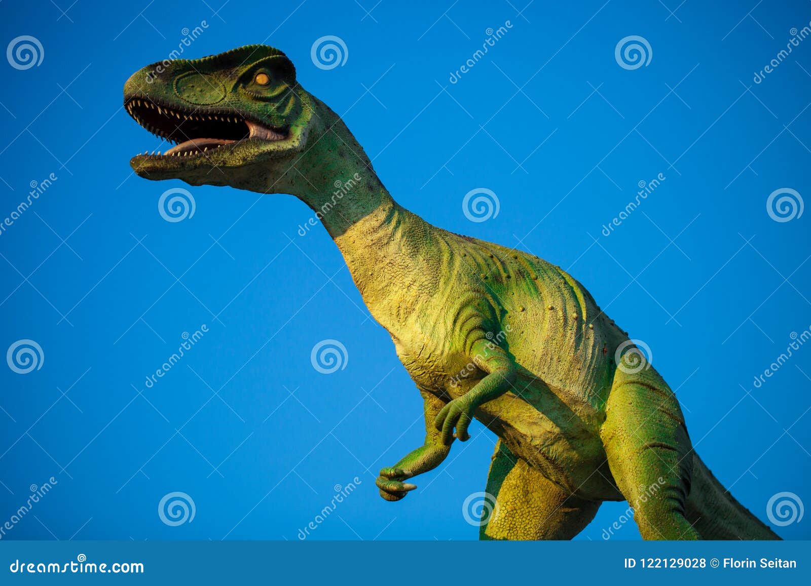 Model of Velociraptor Roaring Against Blue Sky Stock Photo - Image of ...