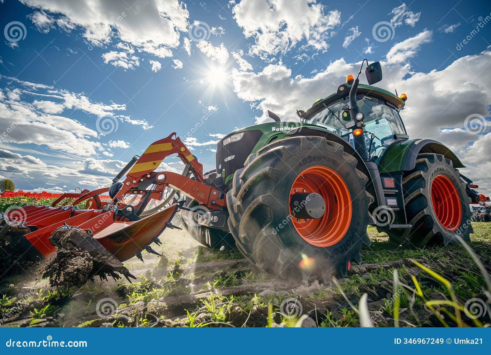 Modern Agricultural Tractor Tilling Soil Under Blue Sky With Clouds ...
