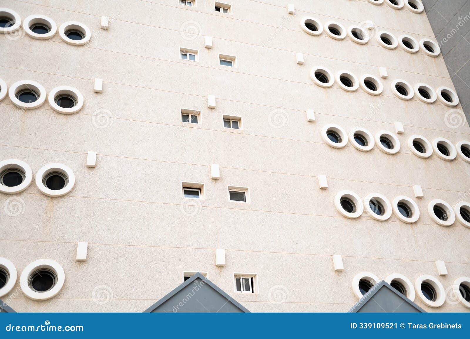 Modern Architectural Facade with Circular Windows in Geometric Pattern ...
