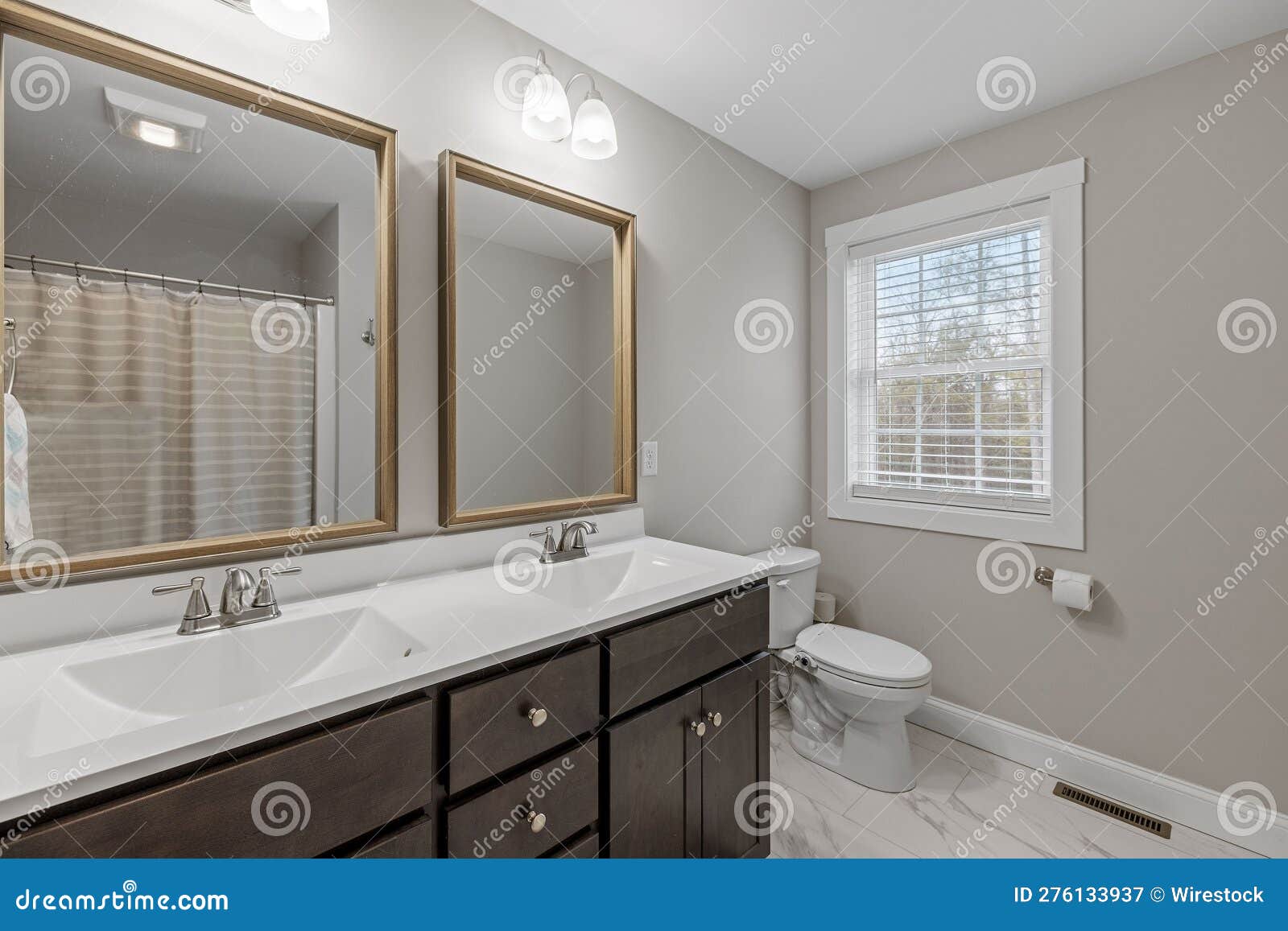 Modern Bathroom with a Double Vanity Equipped with Two Stylish ...