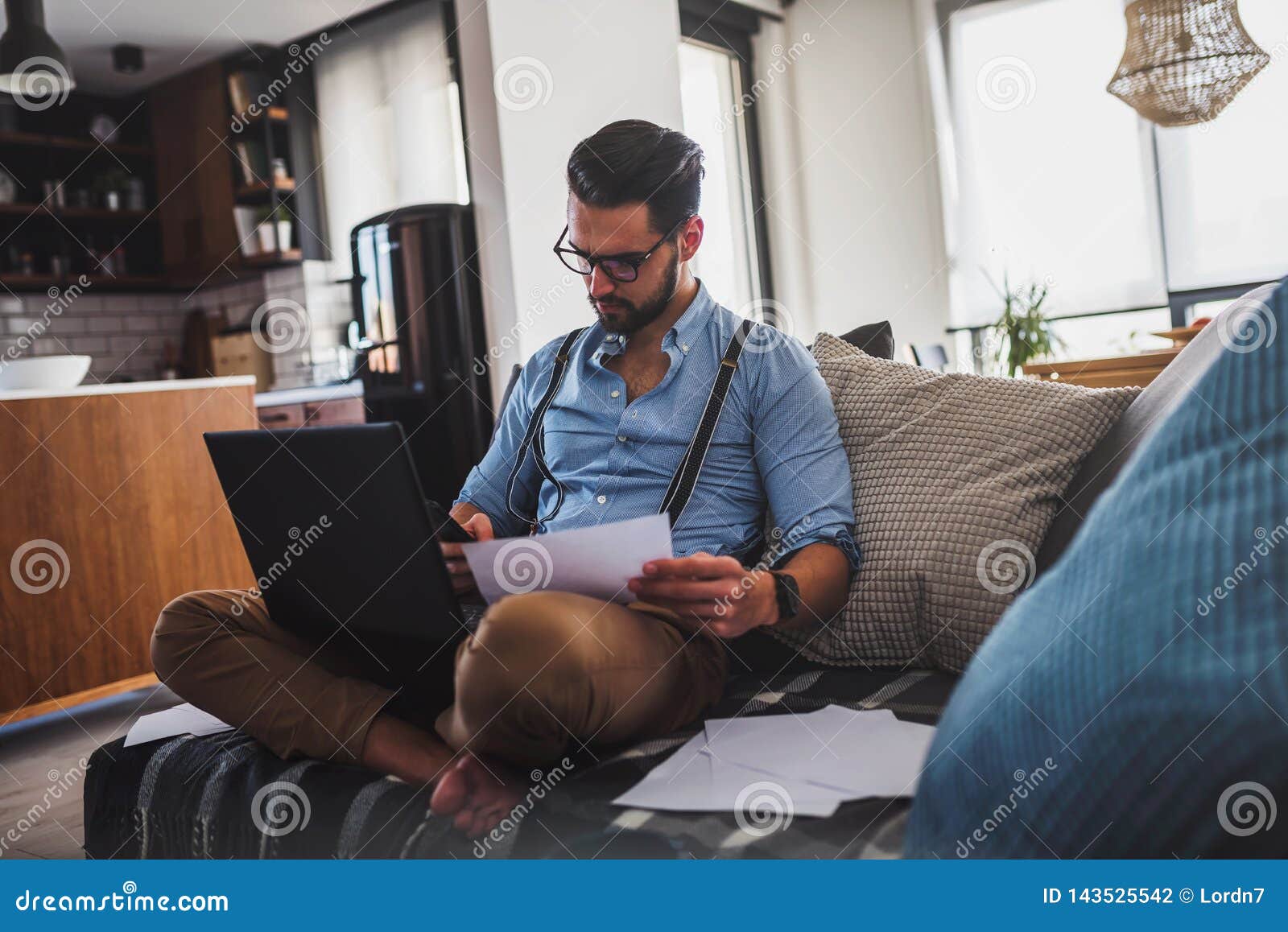 Young Businessman Working on Laptop Computer while Sitting on Sofa at ...