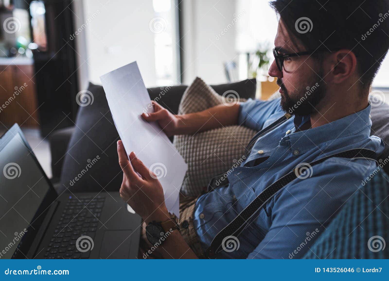 Young Businessman Working on Laptop Computer while Sitting on Sofa at ...