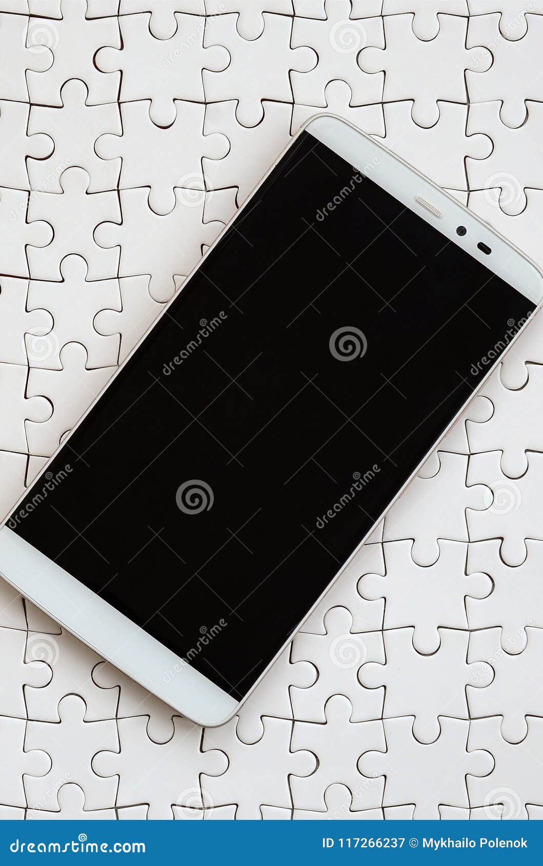 A Modern Big Smartphone with a Touch Screen Lies on a White Jigsaw ...