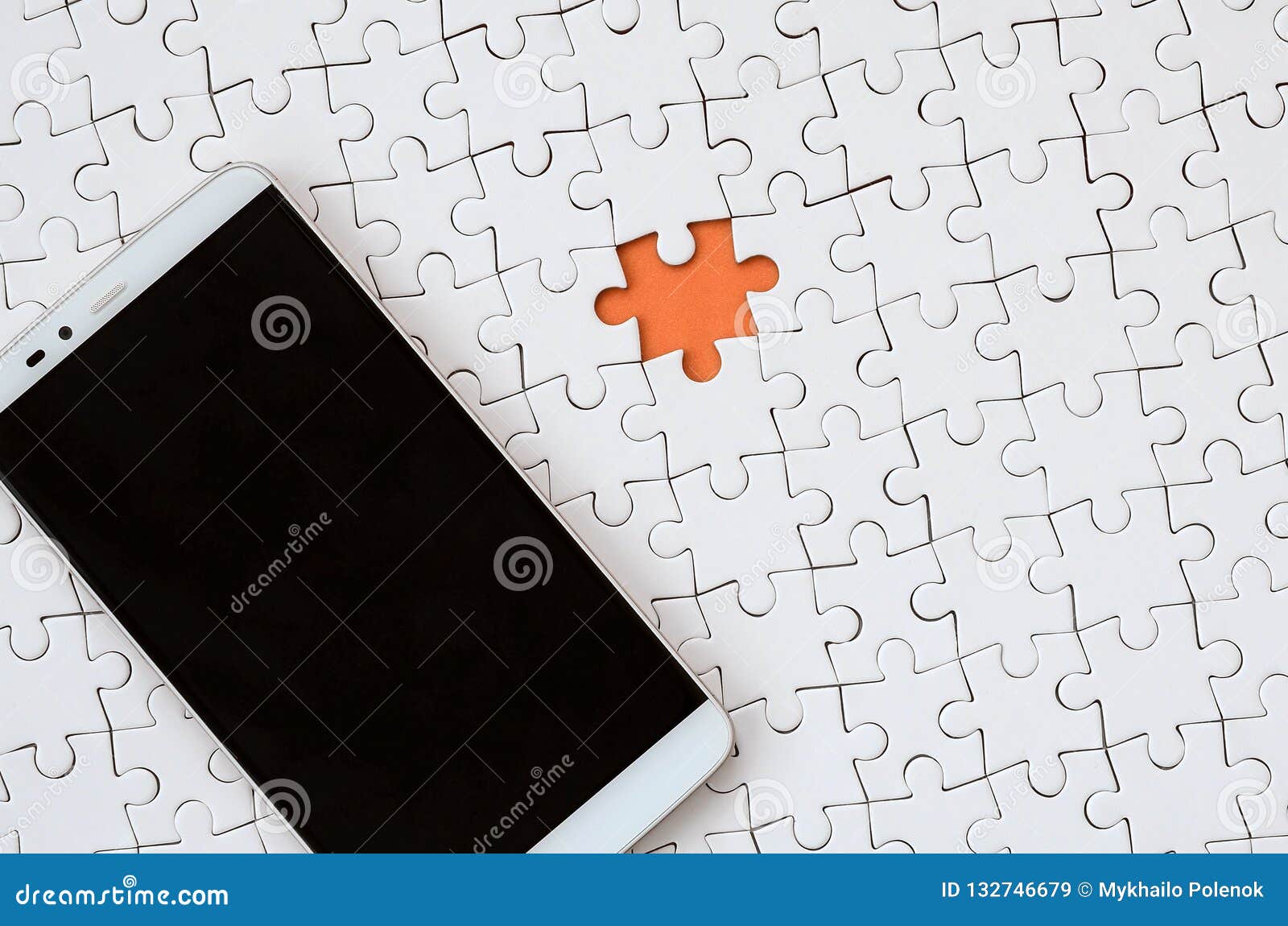 A Modern Big Smartphone with a Touch Screen Lies on a White Jigsaw ...