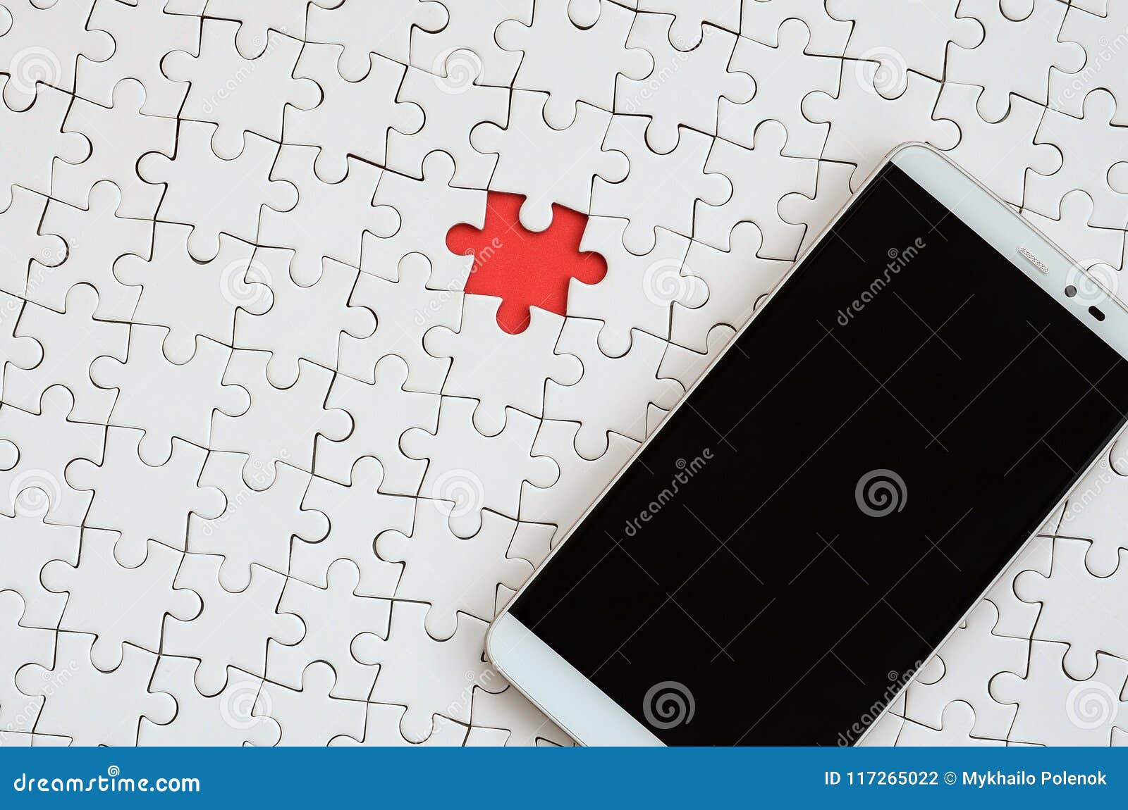 A Modern Big Smartphone with a Touch Screen Lies on a White Puzzle ...