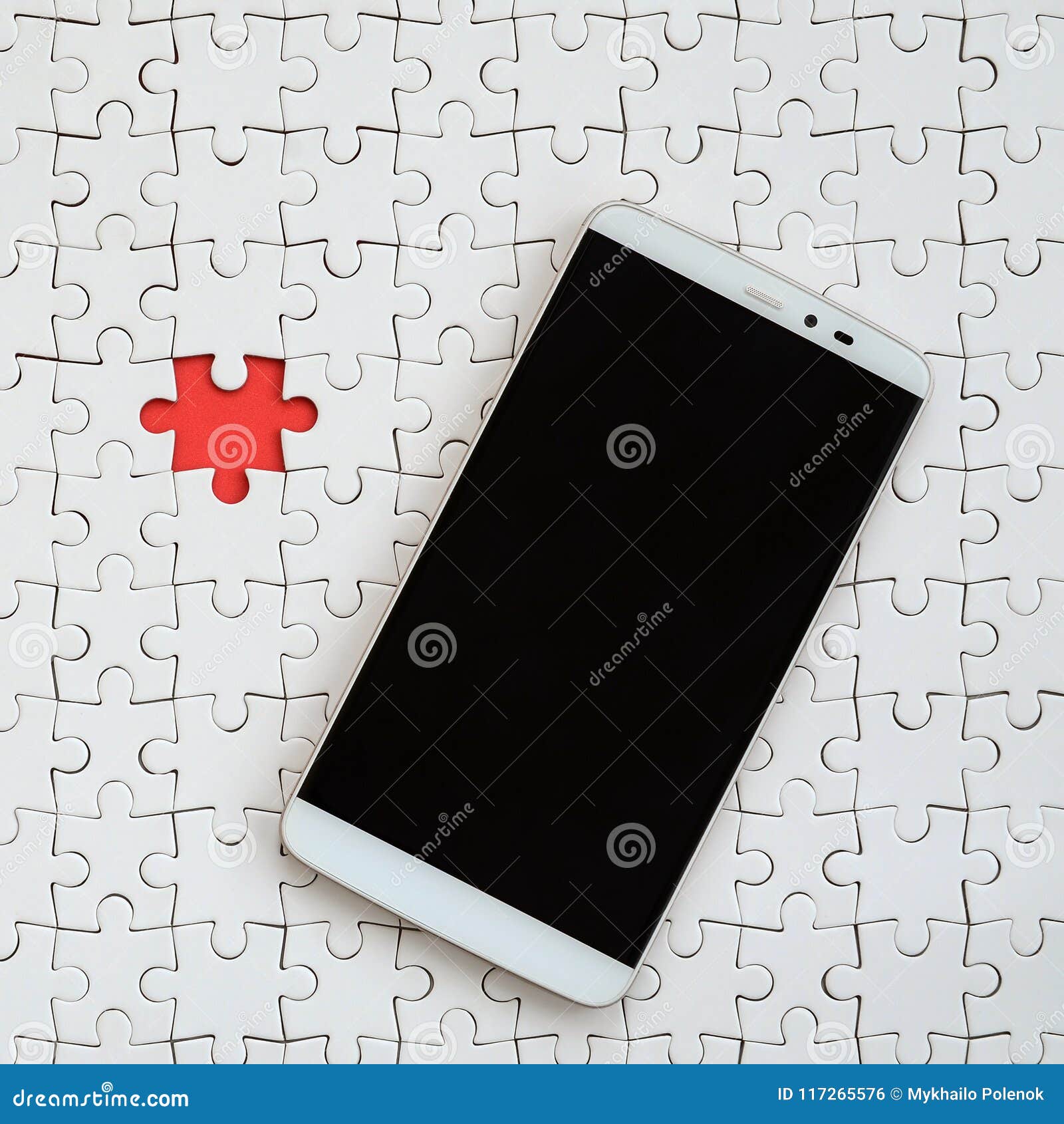 A Modern Big Smartphone with a Touch Screen Lies on a White Puzzle ...