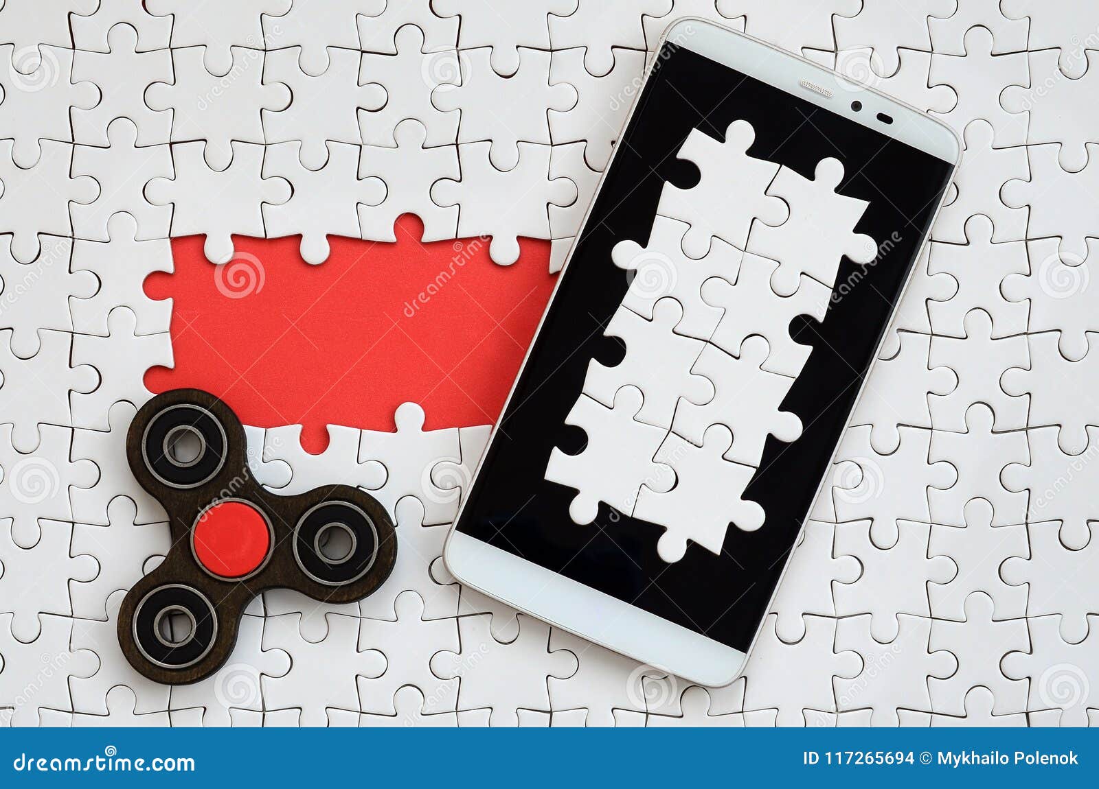 A Modern Big Smartphone with a Touch Screen and a Spinner Lie on a ...