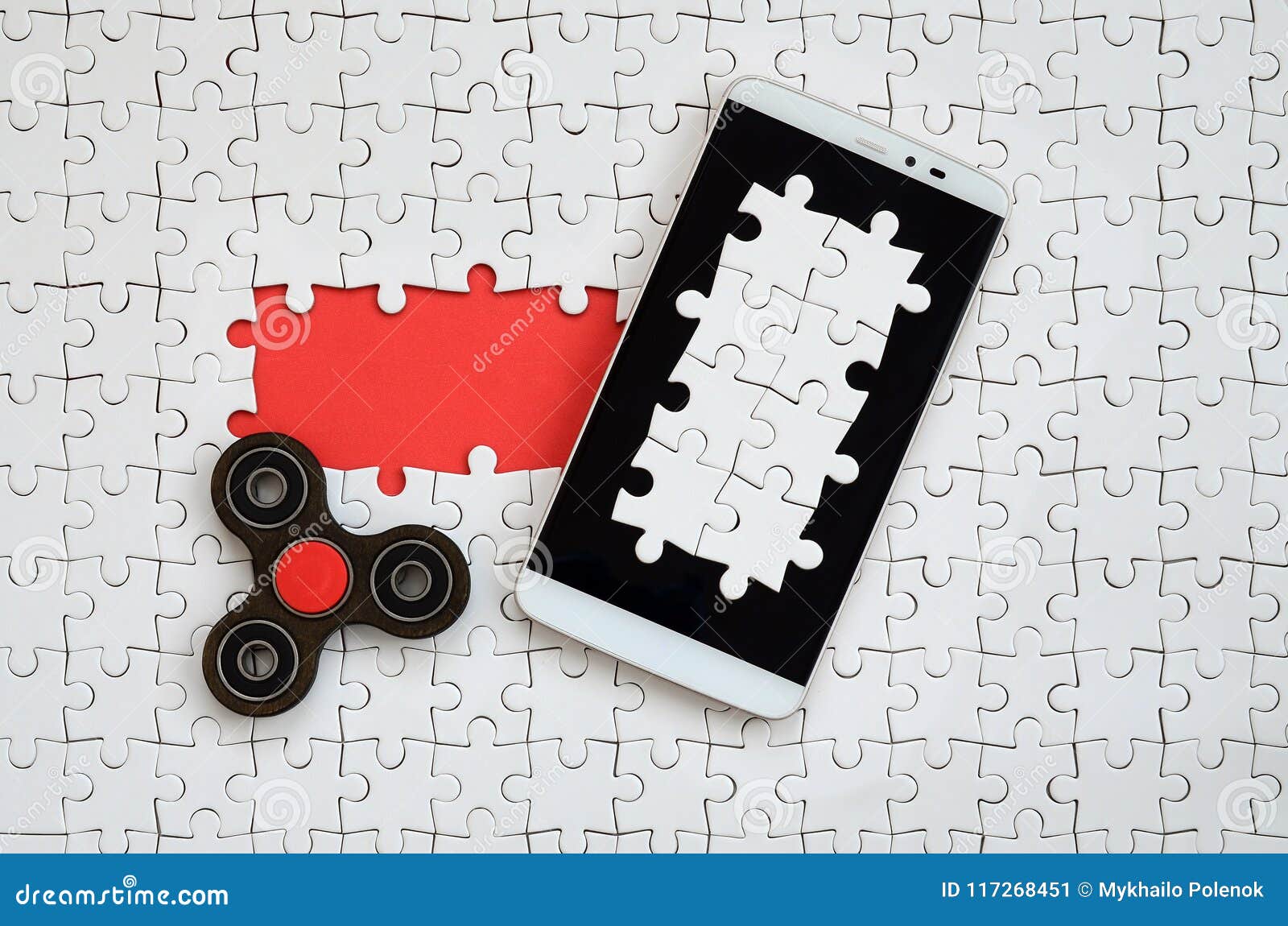 A Modern Big Smartphone with a Touch Screen and a Spinner Lie on a ...