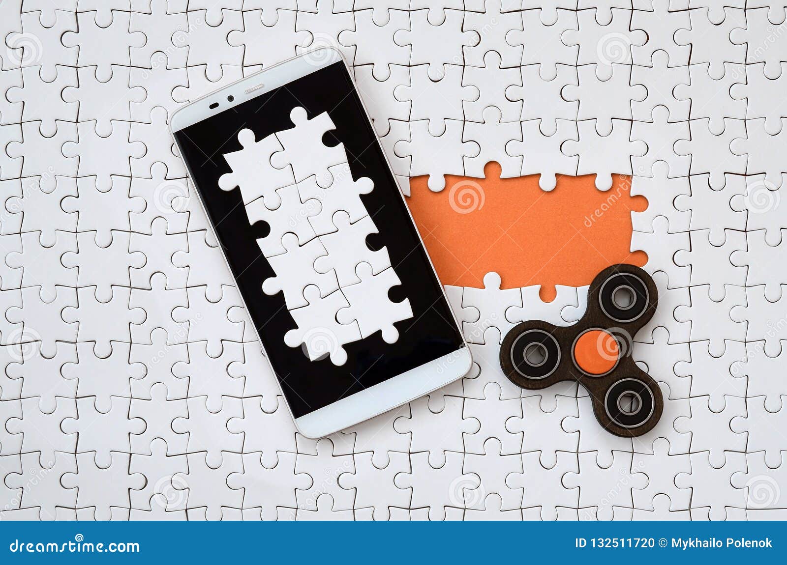 A Modern Big Smartphone with a Touch Screen and a Spinner Lie on a ...