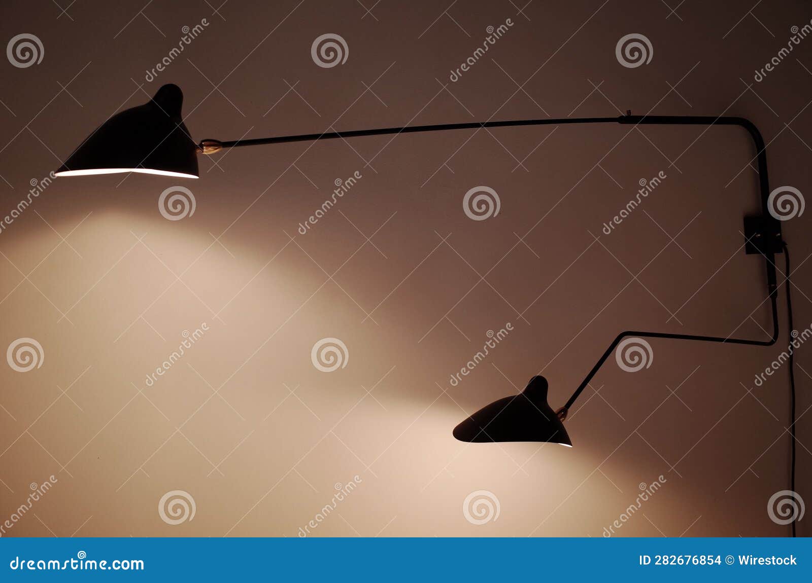 Modern Black Wall Lamp on a White Wall Providing a Soft Yellow Light in ...