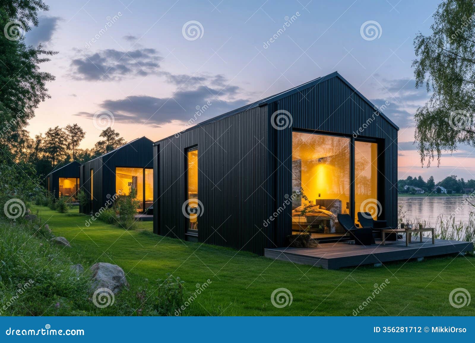 Modern Black Waterfront Homes at Sunset with Large Windows and Spacious ...