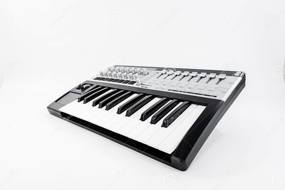 Modern Black and White MIDI Keyboard with Control Pads in a Studio ...