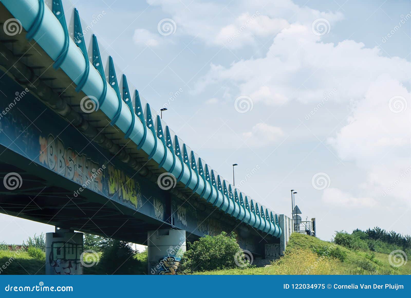 Modern Bridge Over Highway with Graffiti, Beautiful Blue Sky and White ...
