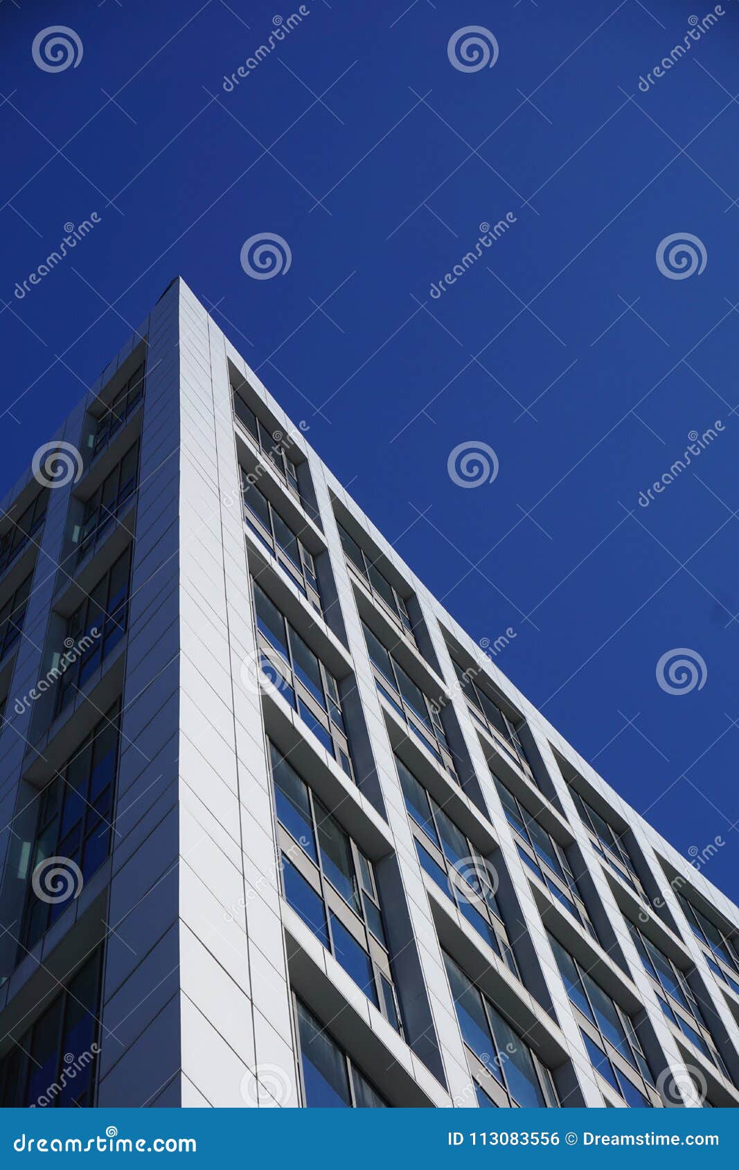 Modern Building with Windows on Blue Sky Background. Stock Photo ...