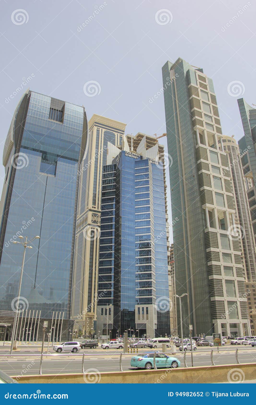Modern buildings in Doha editorial photography. Image of crane - 94982652