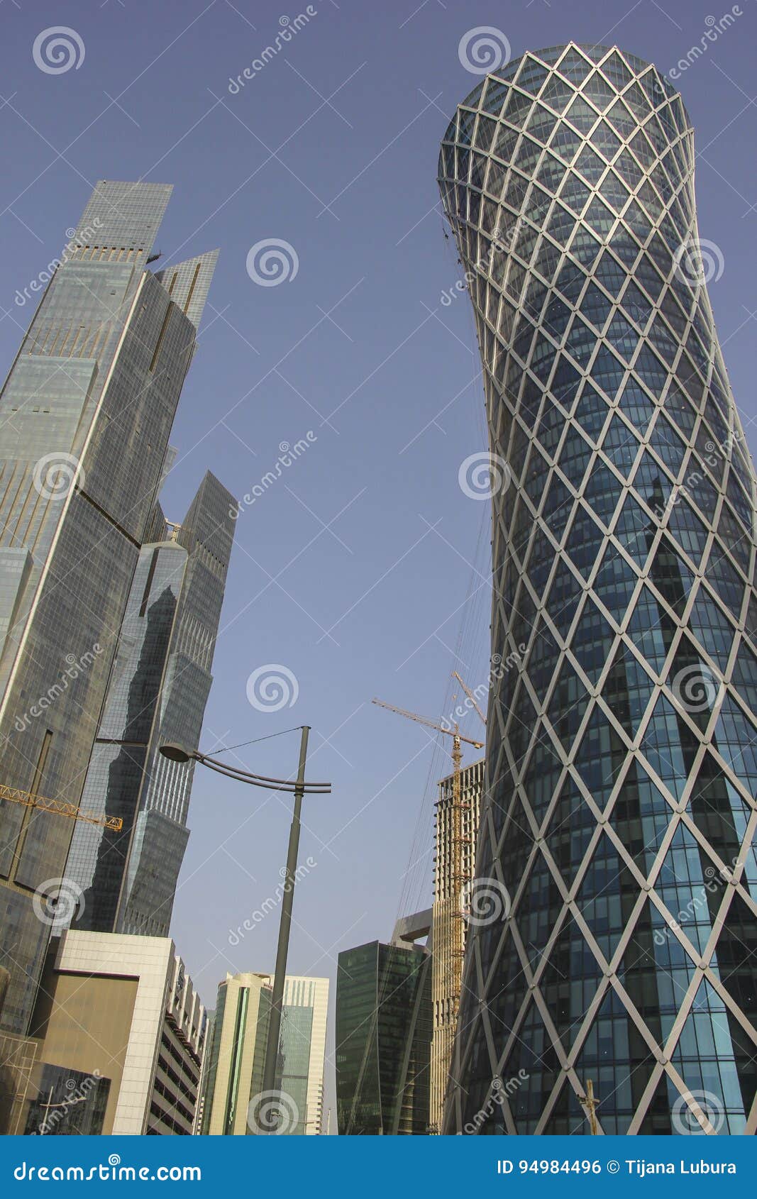 Modern buildings in Doha editorial photo. Image of crane - 94984496