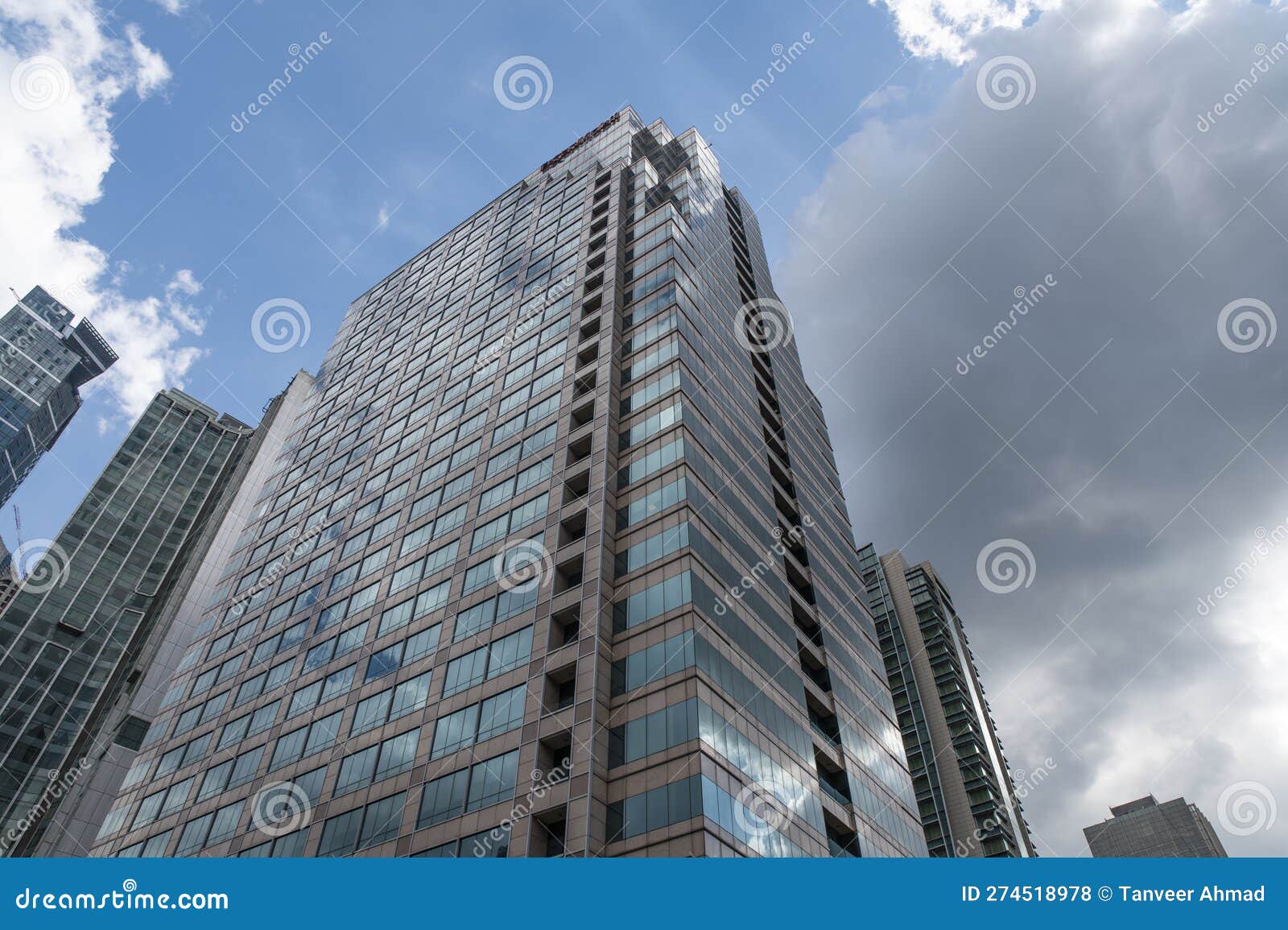 Modern Business Hub Building with Dark Clouds in Background Stock Photo ...
