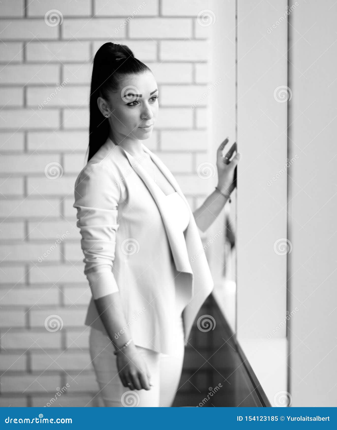 Modern Business Woman Standing Near The Window In The Corridor Stock