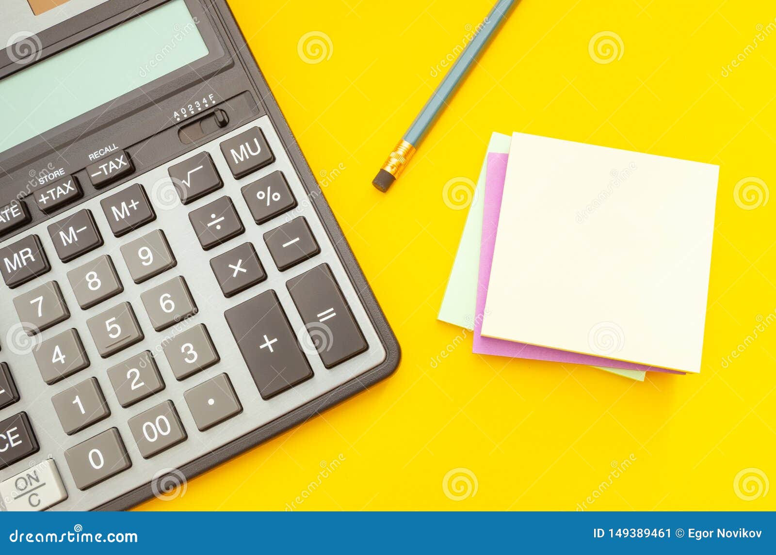 Modern Calculator and Pencil with Stickers for Notes on a Yellow ...