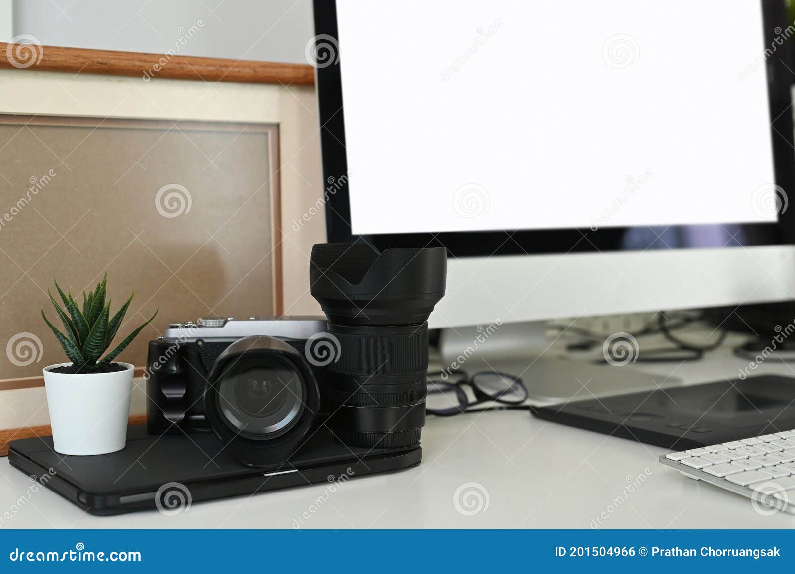 A Modern Camera with Lens on Graphic Designer or Photographer Workspace ...