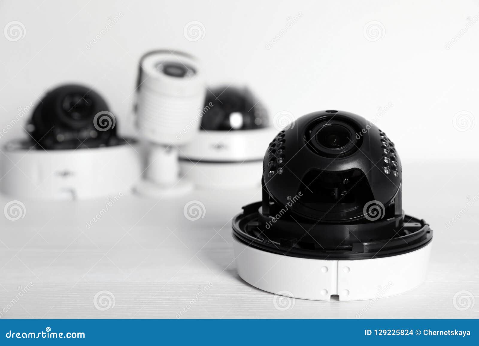 Modern CCTV Cameras on Table Against Light Background Stock Photo ...