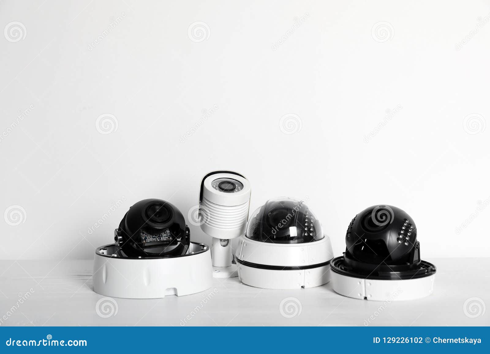 Modern CCTV Cameras on Table Against Light Background Stock Photo ...