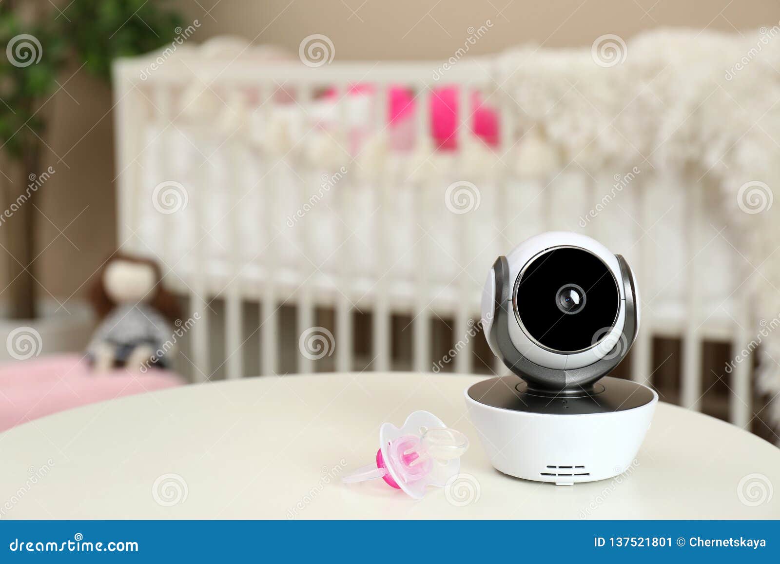 Modern CCTV Security Camera and Pacifier on Table in Nursery. Stock ...