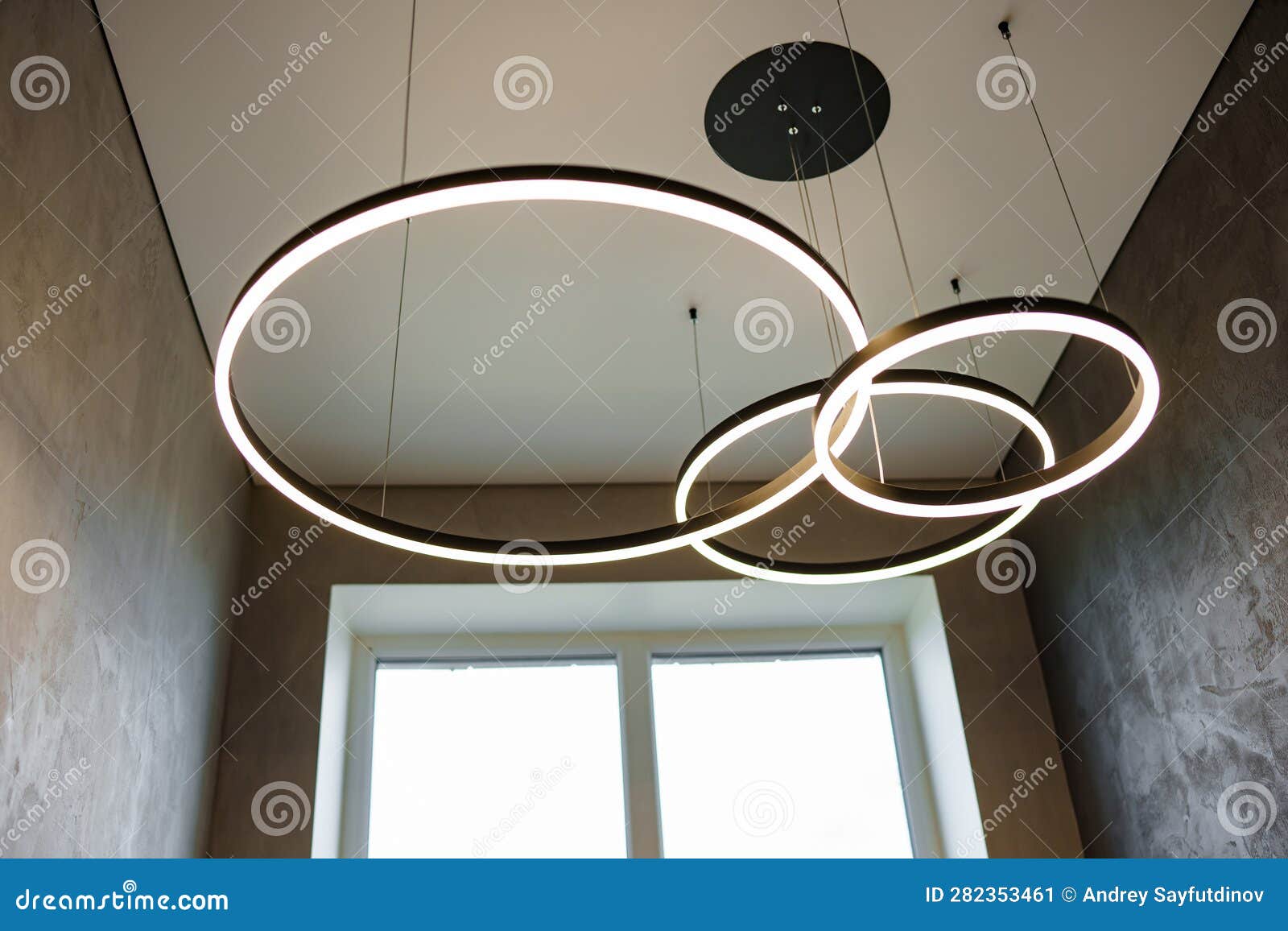 Modern Ceiling Lamp of Three Rings in the Interior. Stock Image - Image ...