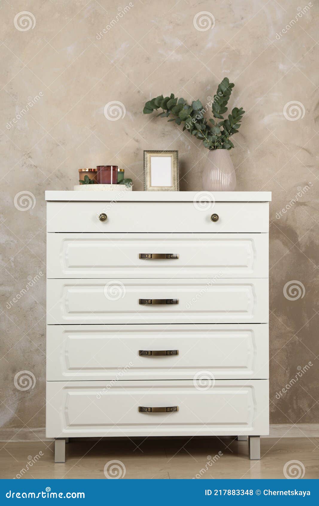 Modern Chest of Drawers with Decor Near Beige Wall Stock Photo - Image ...