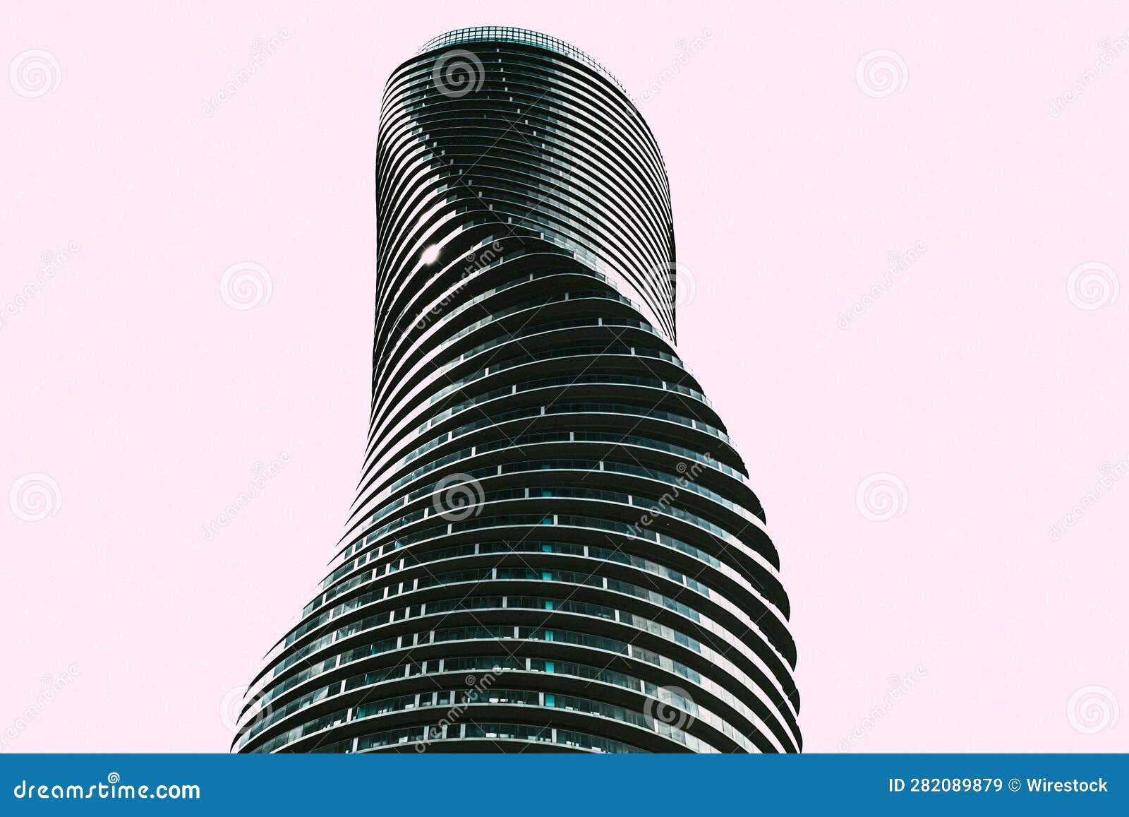 Modern Cityscape Featuring a Tall Building with Curved Edifices ...
