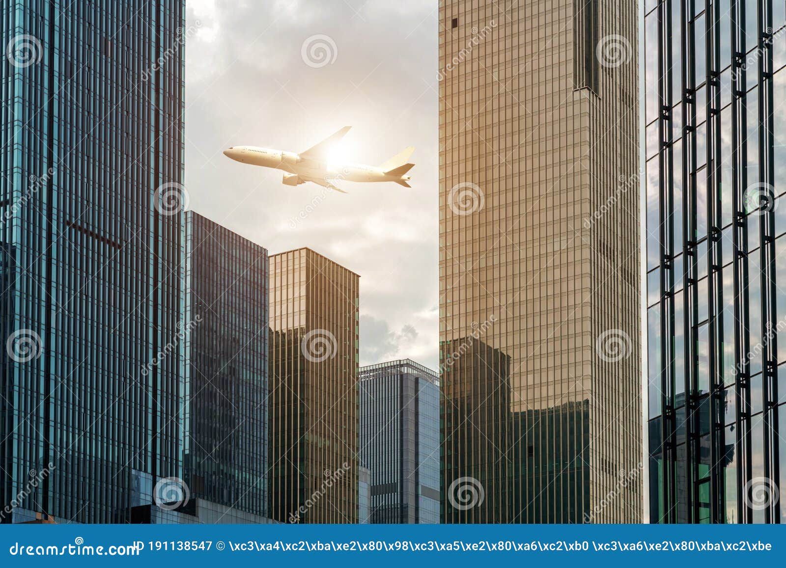 Airplane Fly Over Modern Cityscape and Office Buildings during Sunrise ...