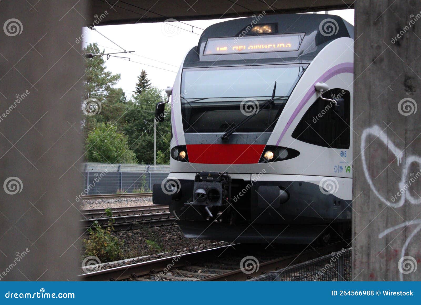 Modern Commuter Train on Rails with Trees in the Background Stock Photo ...
