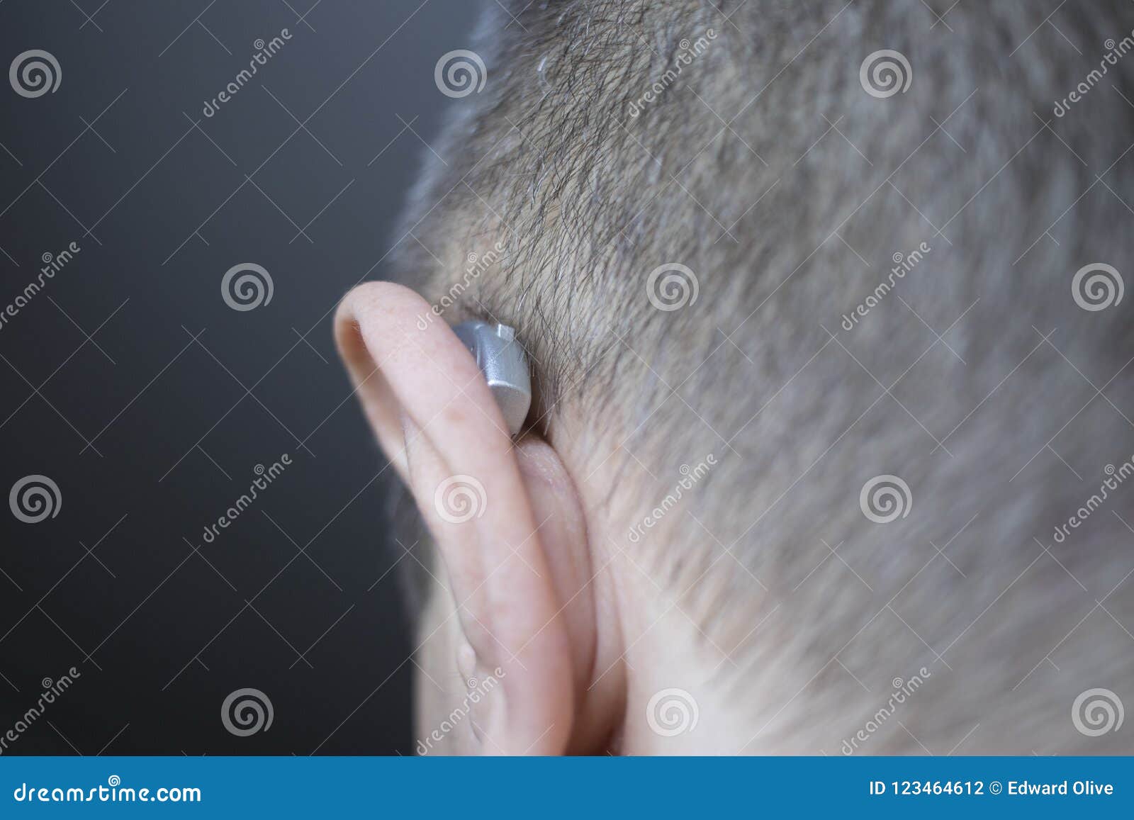 Hearing aid in ear of man stock photo. Image of sound - 123464612