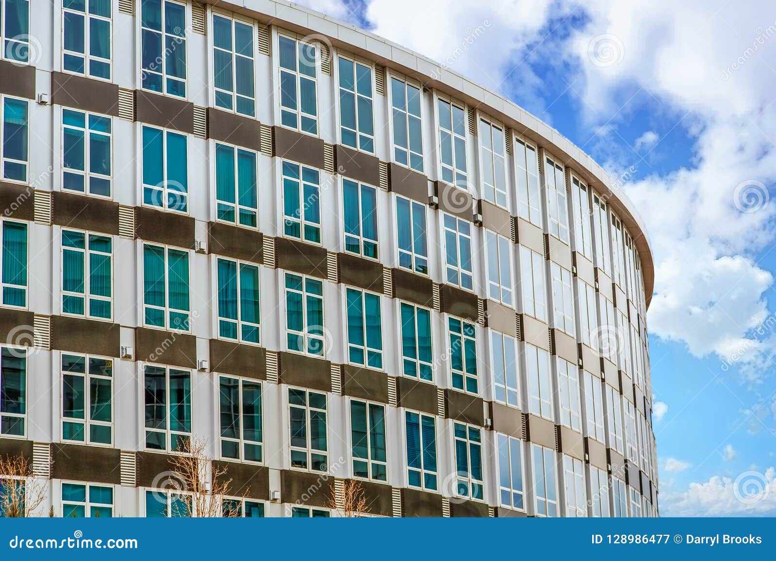 Blue Windows on Brown and Silver Curved Building Stock Image - Image of ...