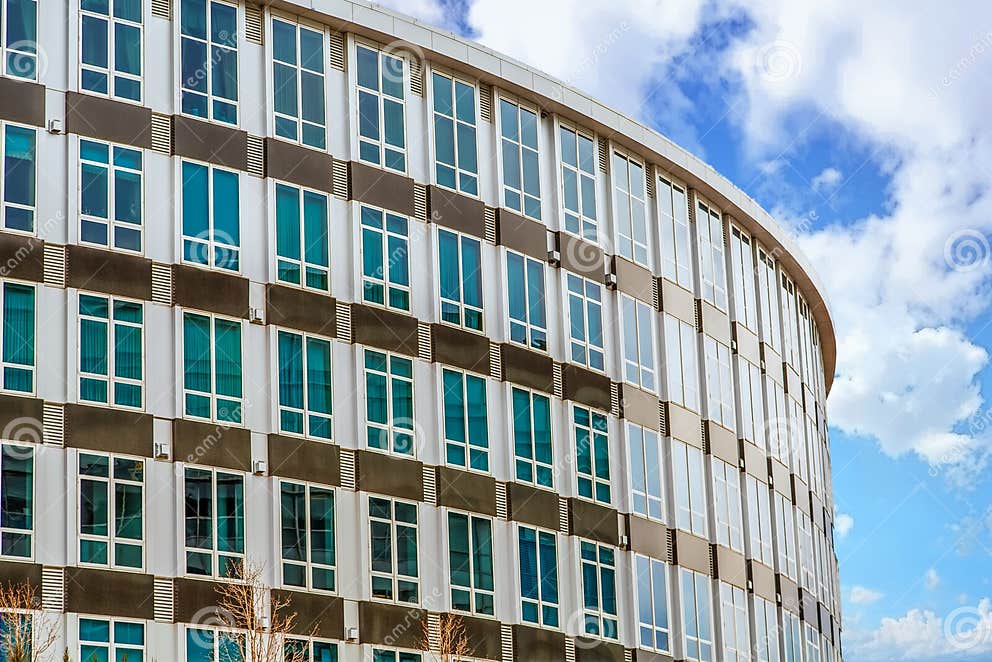 Blue Windows on Brown and Silver Curved Building Stock Image - Image of ...
