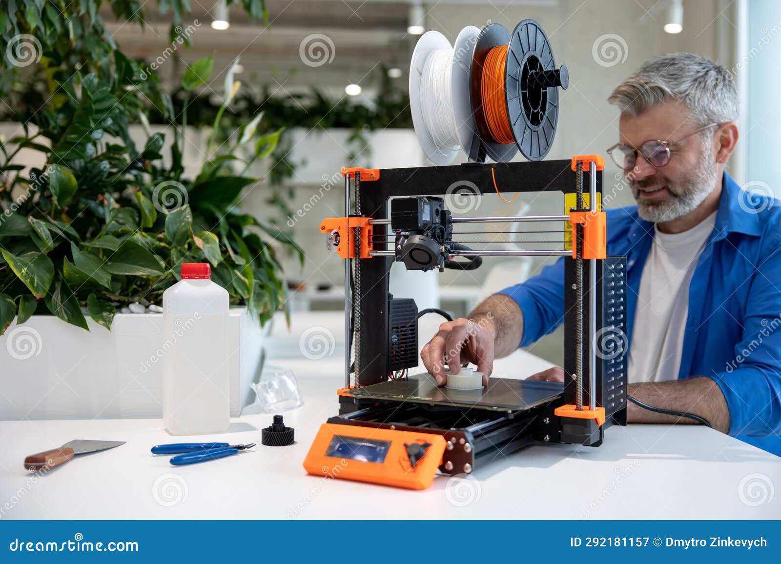 Modern 3D Printer Equipment and Man Working with it in Office. Stock ...