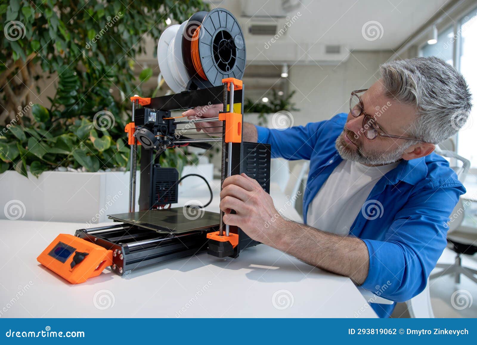 Modern 3D Printer Equipment and Man Working with it in Office. Stock ...