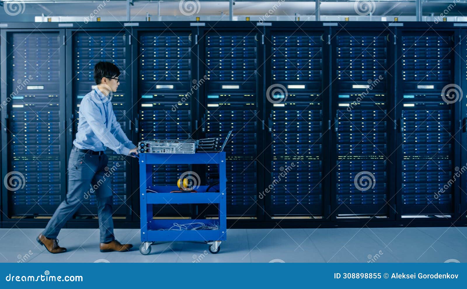In the Modern Data Center: it Engineer Pushes Cart Alongside Server ...