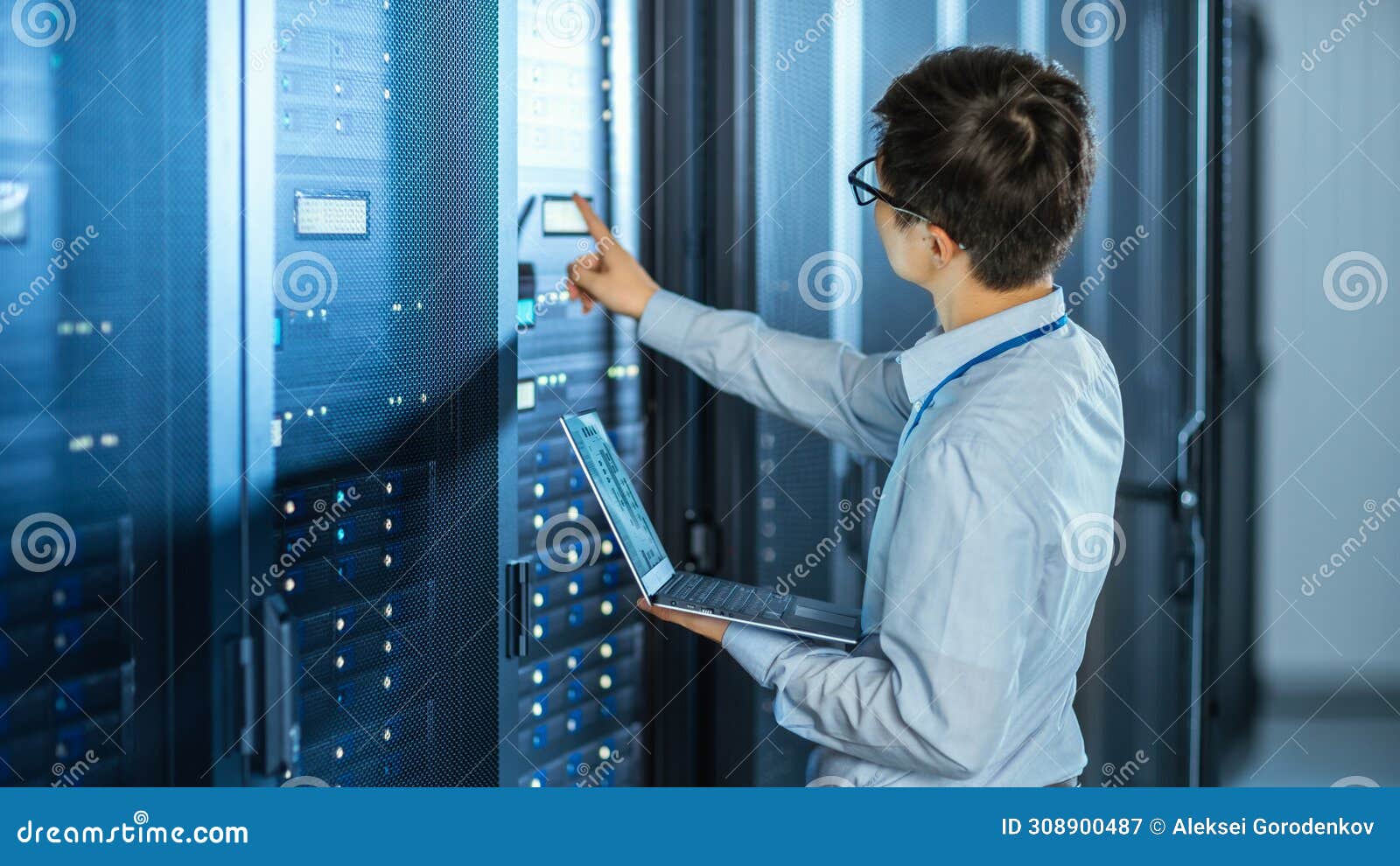 In the Modern Data Center: it Engineer Standing beside Open Server Rack ...